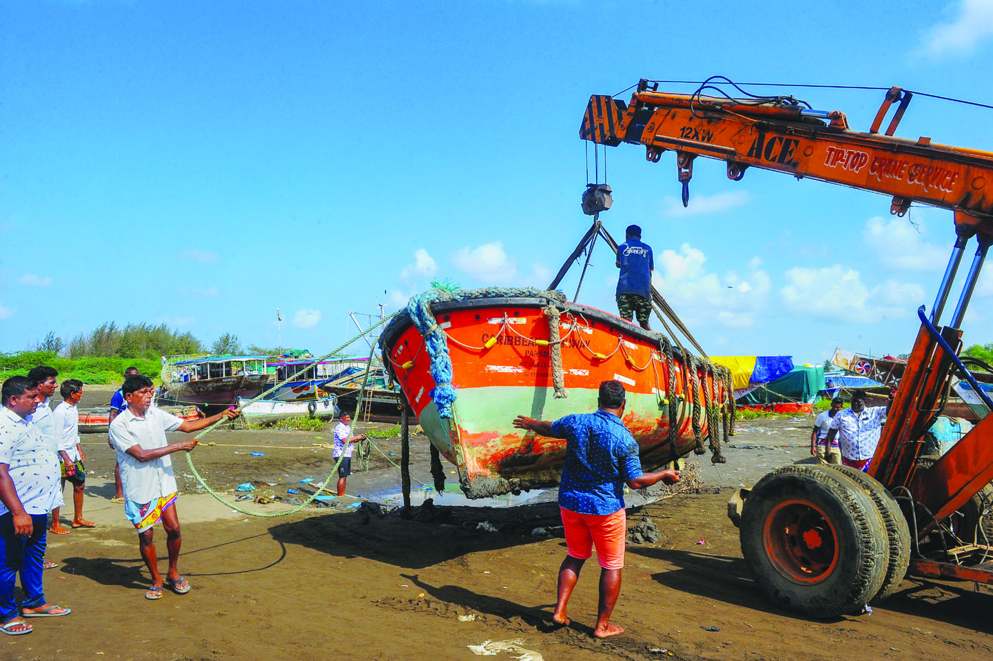 Fishermen pull out a boat towards the shore as the region braces for ...